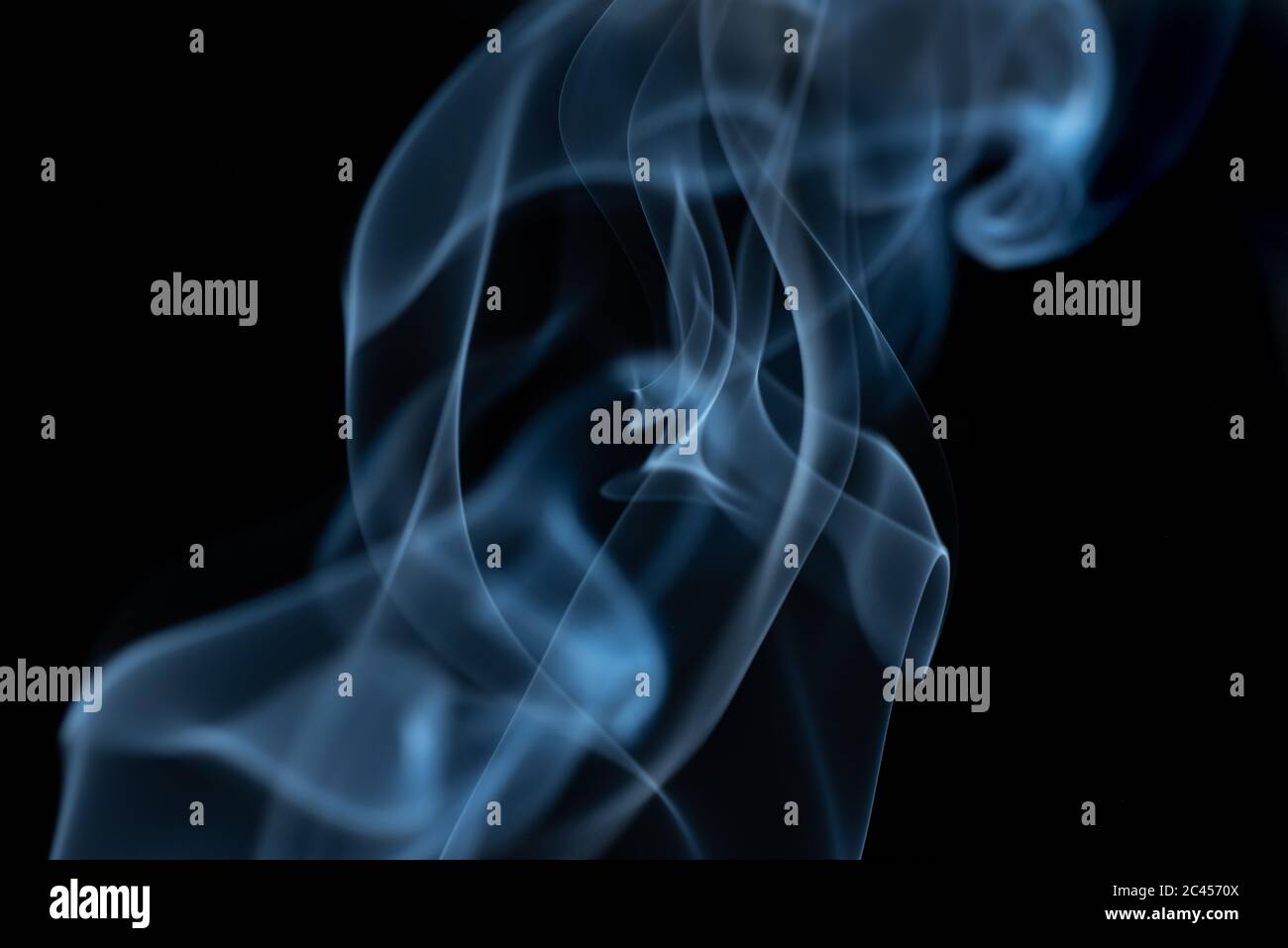 Shot of smoke with blue light effects isolated on a black background ...