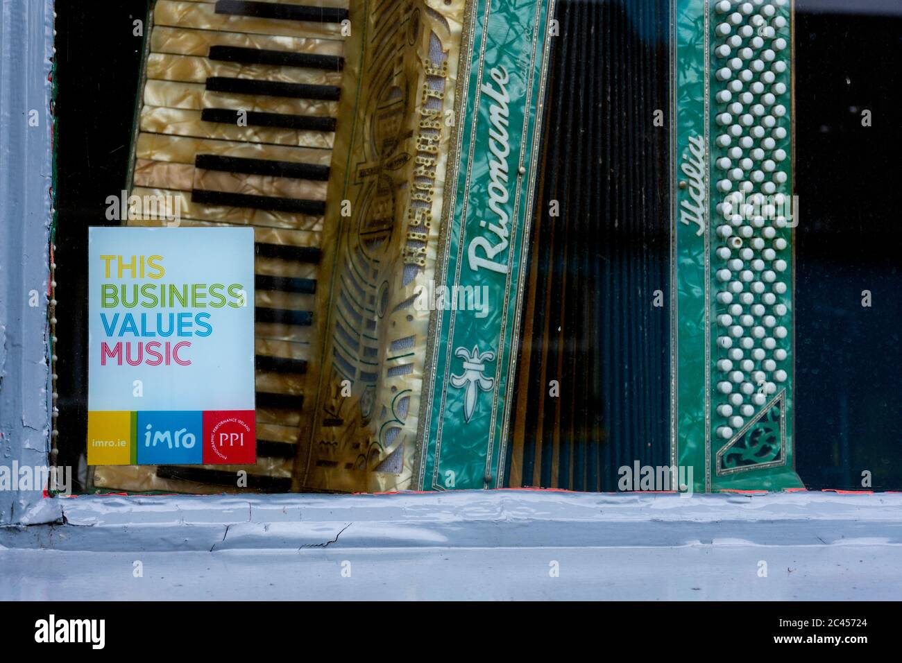Window of a traditional music bar showing IMRO sticker with antique ...