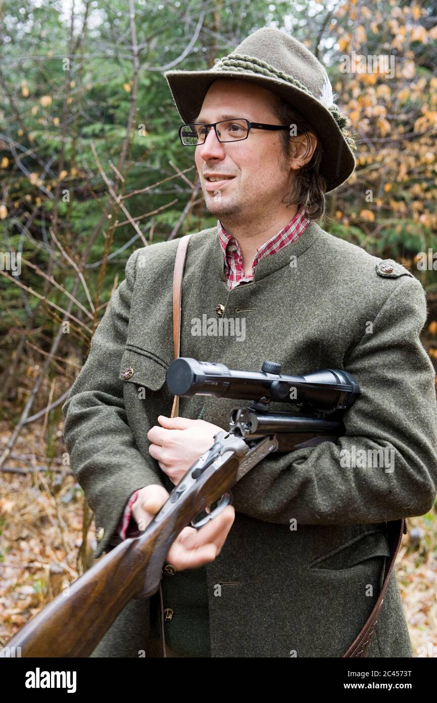 Hunter with rifle in the forest Stock Photo - Alamy