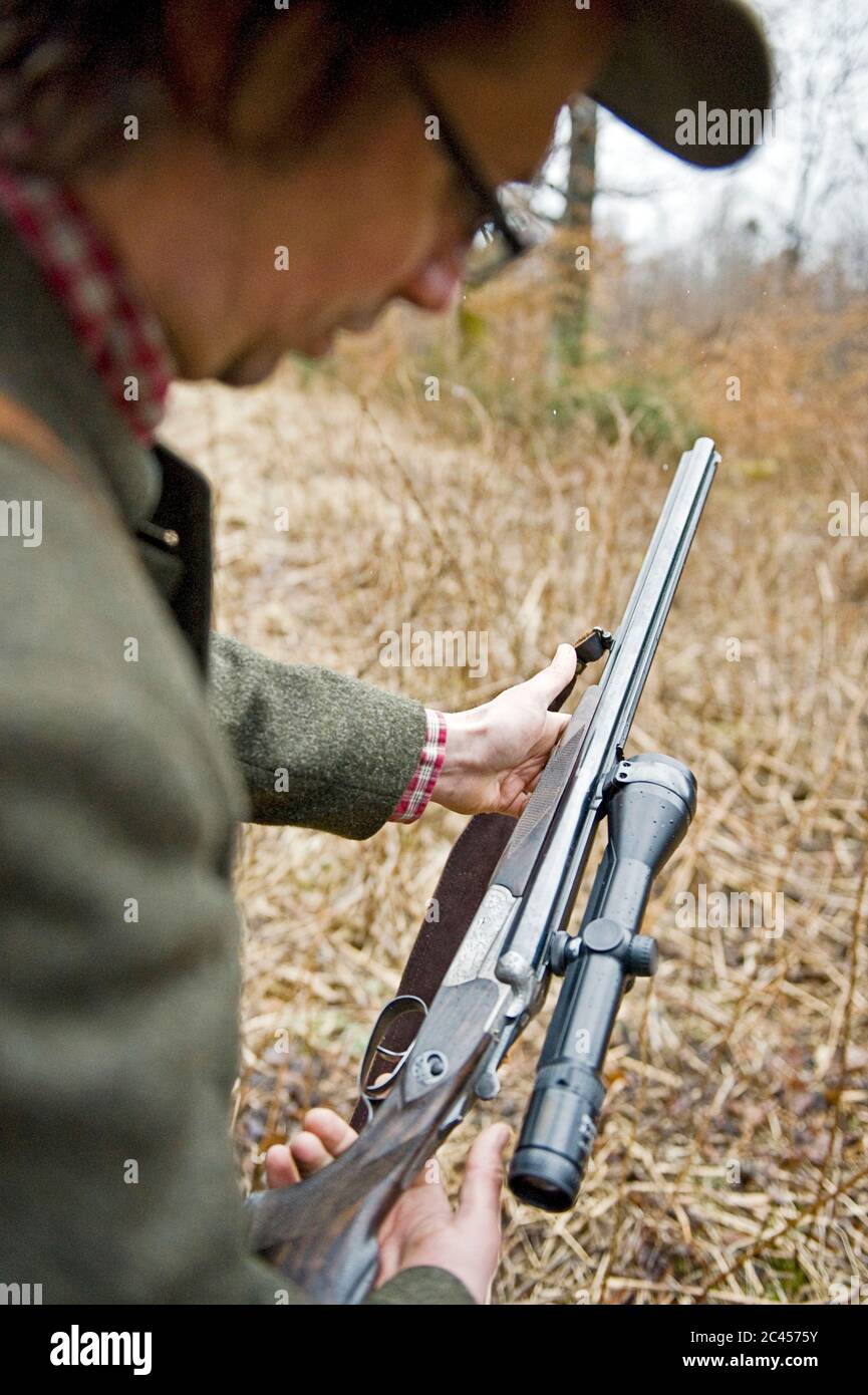 Hunter with rifle in the forest Stock Photo - Alamy