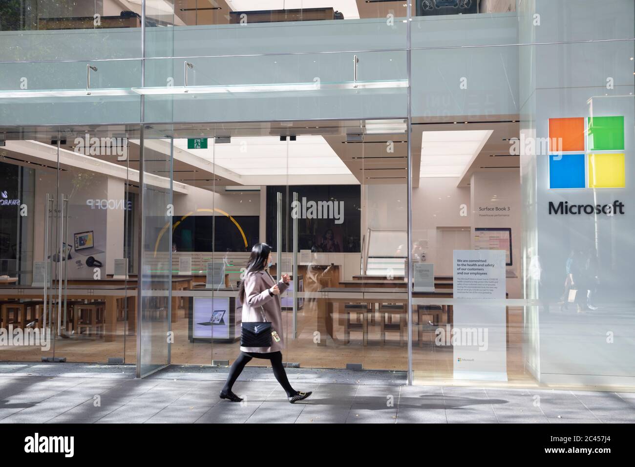 Woman looks into closed Microsoft store during covid 19 pandemic in ...