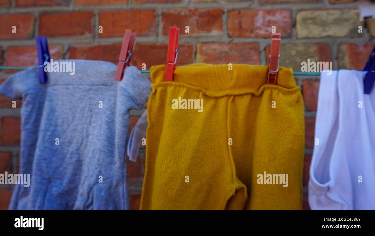 Colorful clothes hanging on the laundry rope with clothespins Stock ...