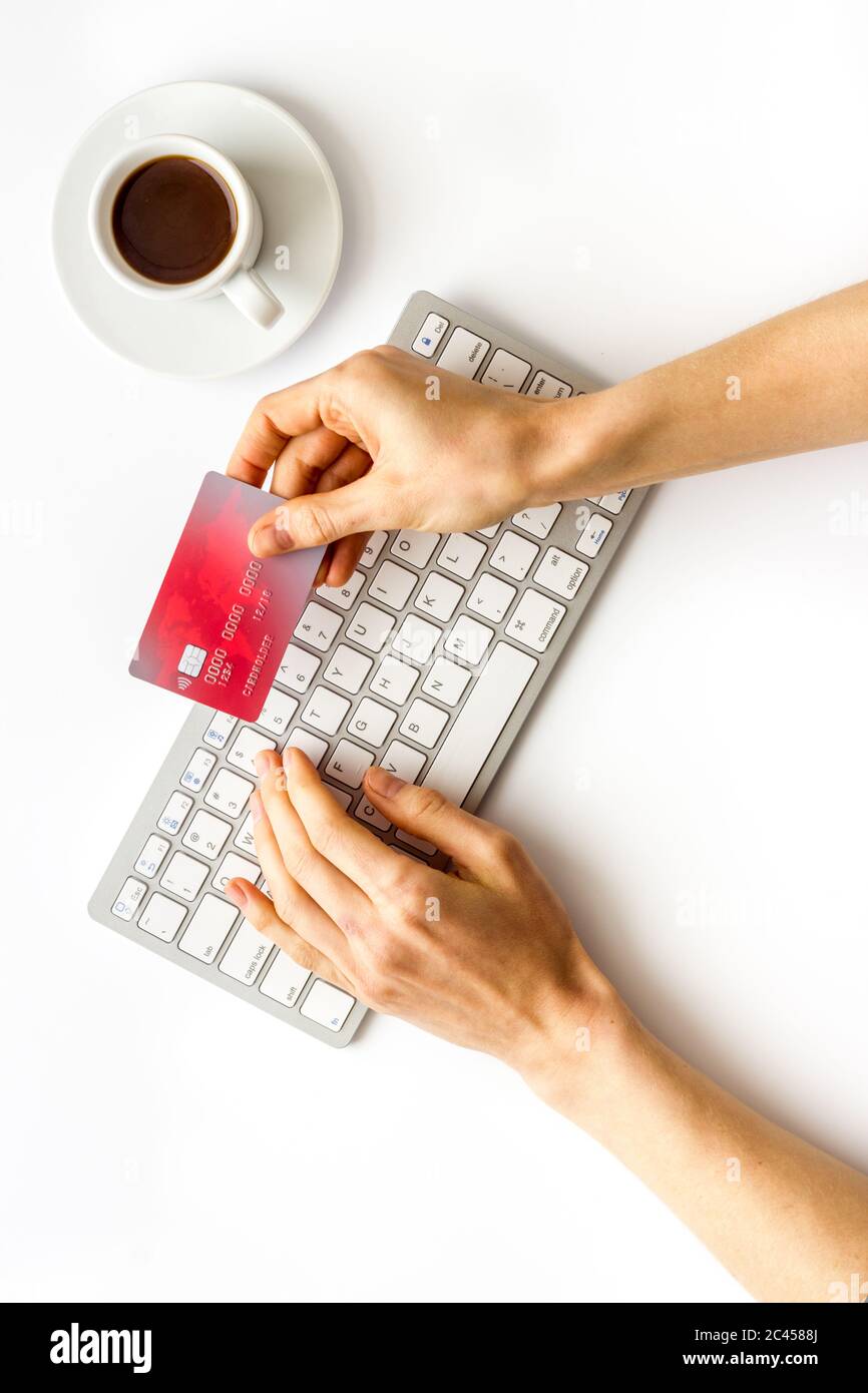 shopping online payment. Hand enter data on keyboard on white desk top ...