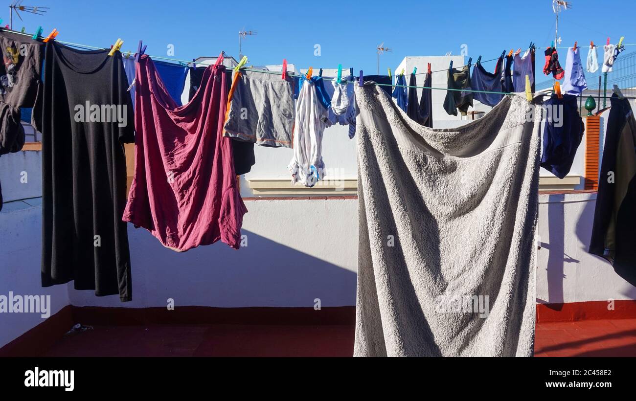 Colorful clothes hanging on the laundry rope Stock Photo - Alamy