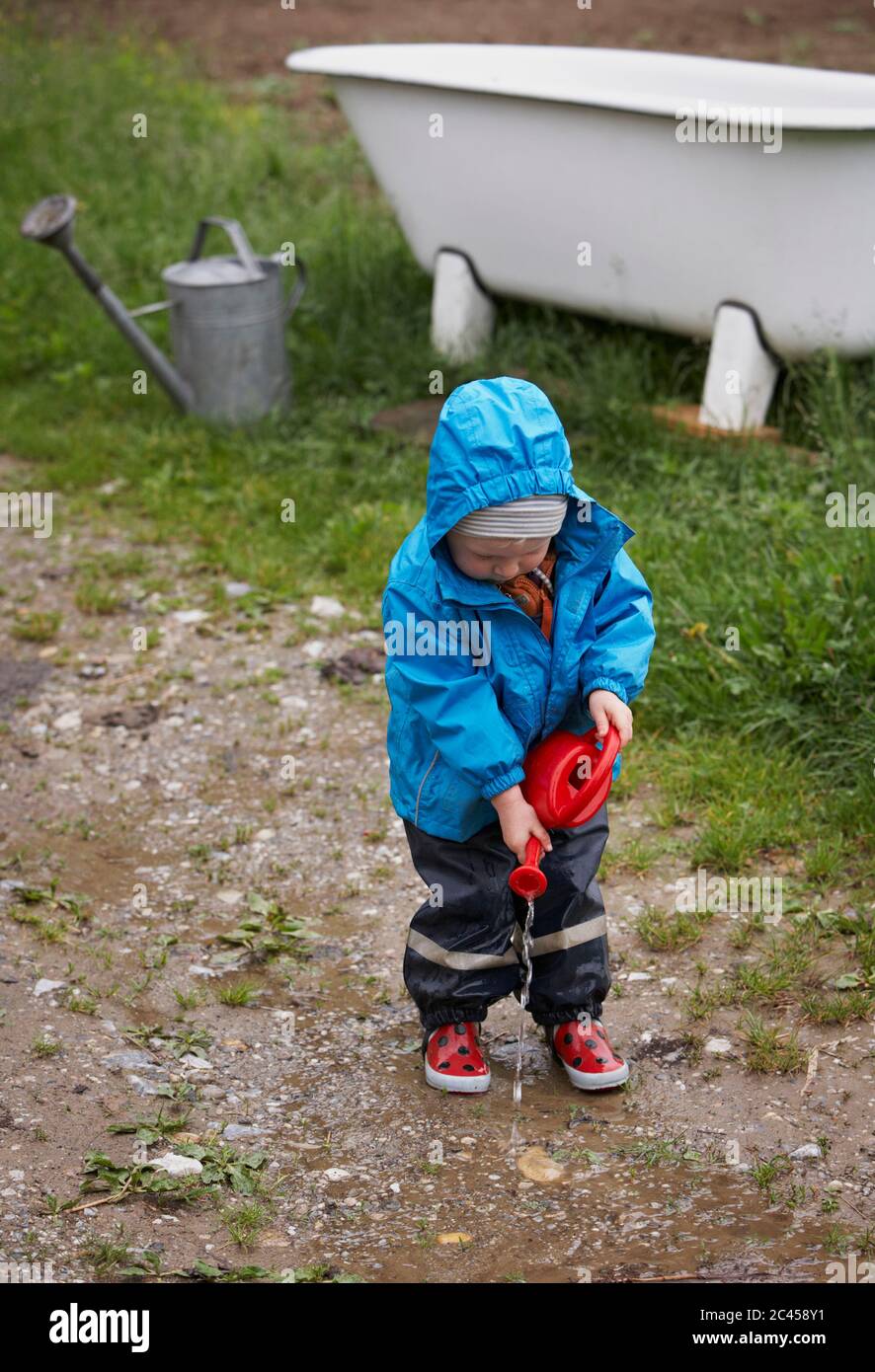 Toddler is playing in the rain Stock Photo - Alamy