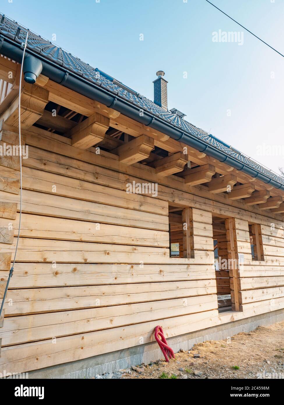 Popular wooden house wall built from white natural logs. Construction ...