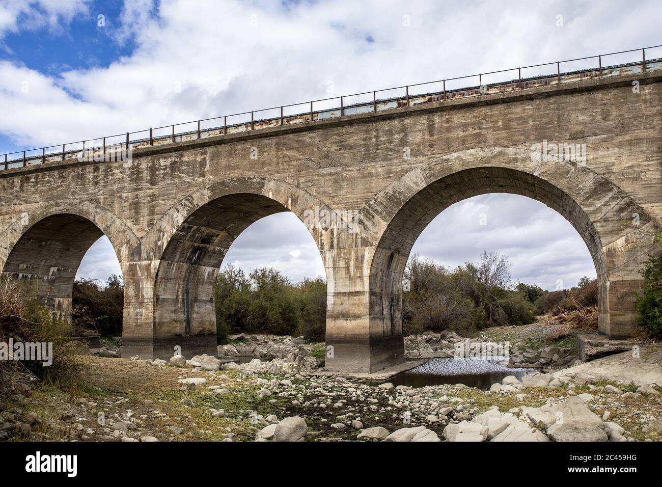 Stone bridge with arches and a cloudy sky Stock Photo - Alamy