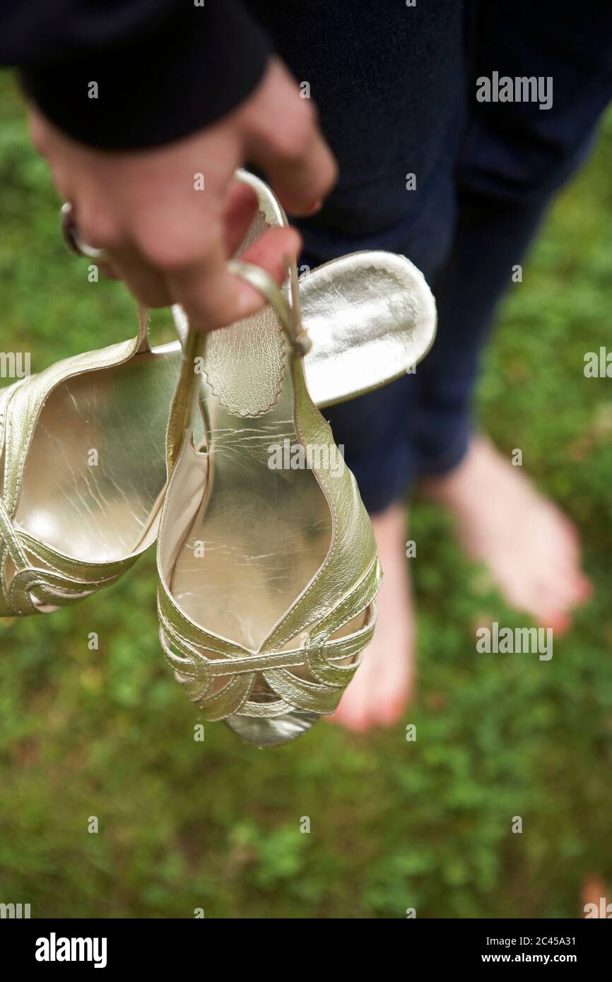 Woman holds pair shoes hi-res stock photography and images - Alamy