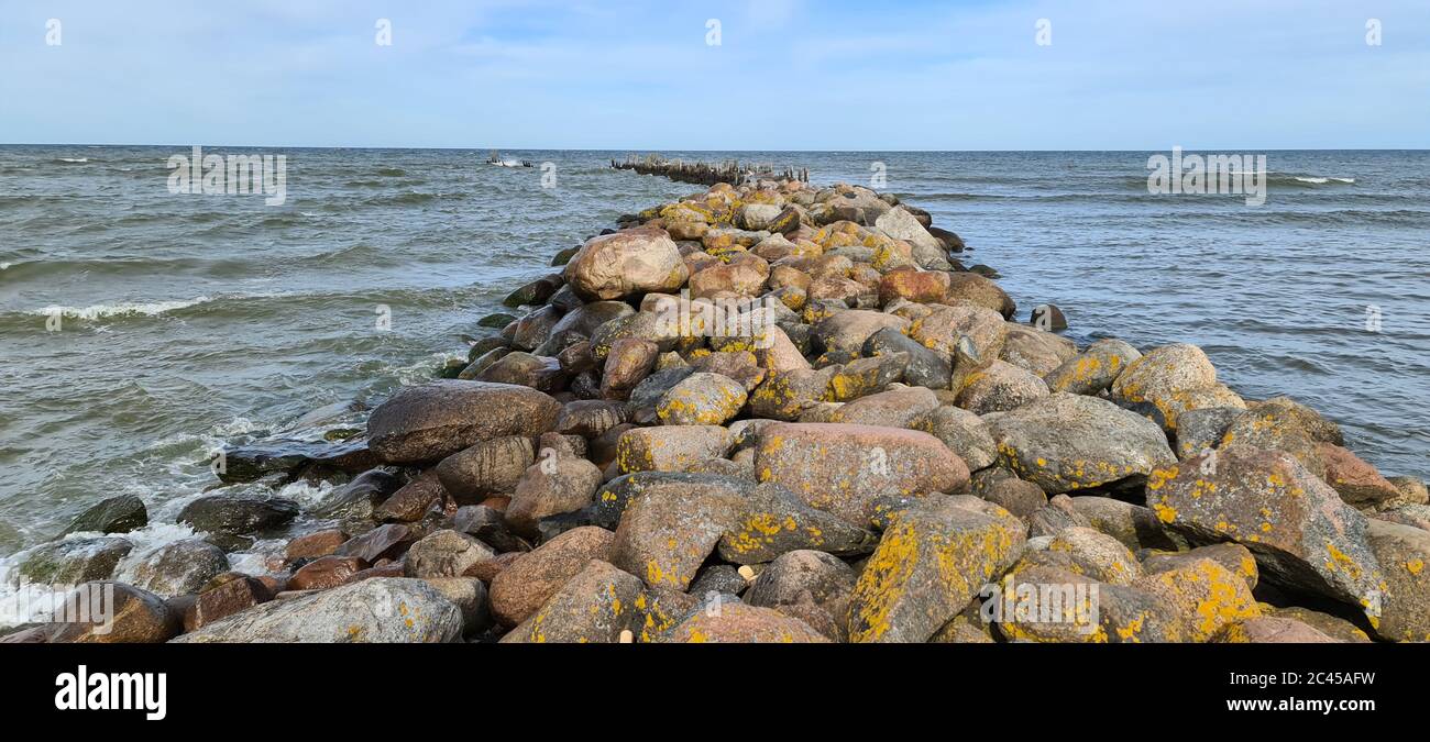 A pier made of large stones in the Baltic Sea Stock Photo - Alamy