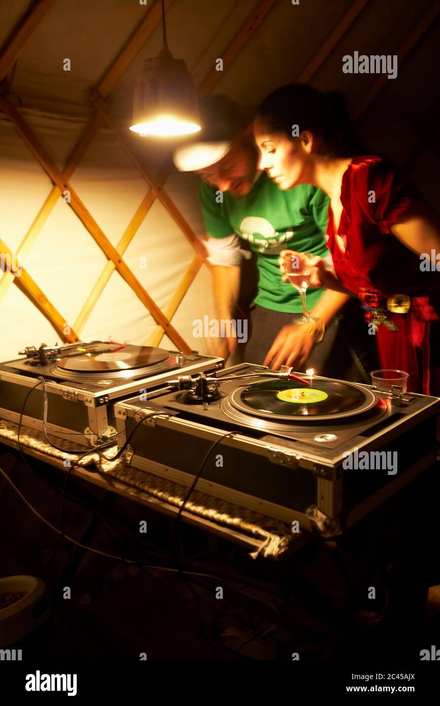 Man and woman on record player Stock Photo - Alamy