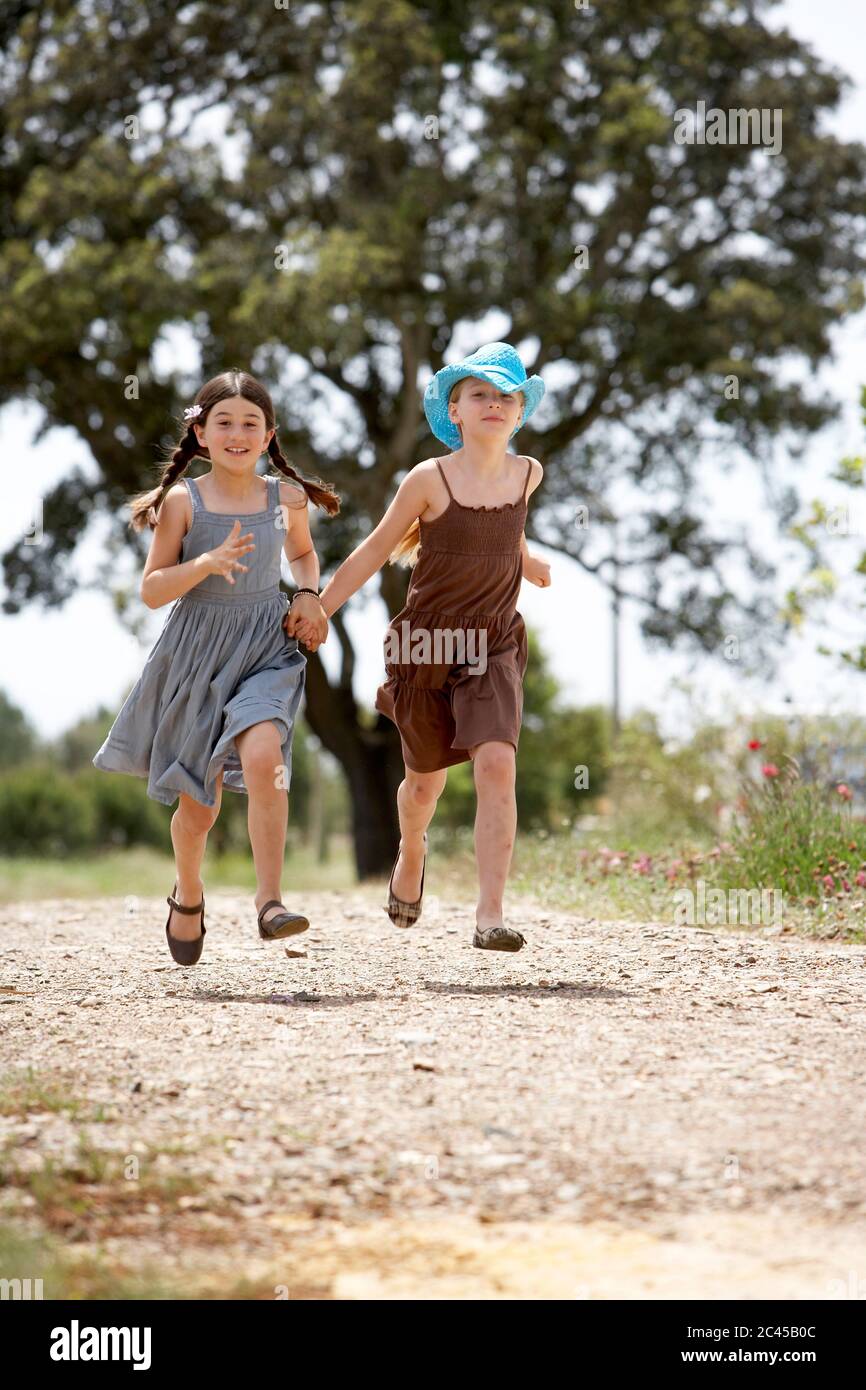 Two girls walk hand hi-res stock photography and images - Alamy