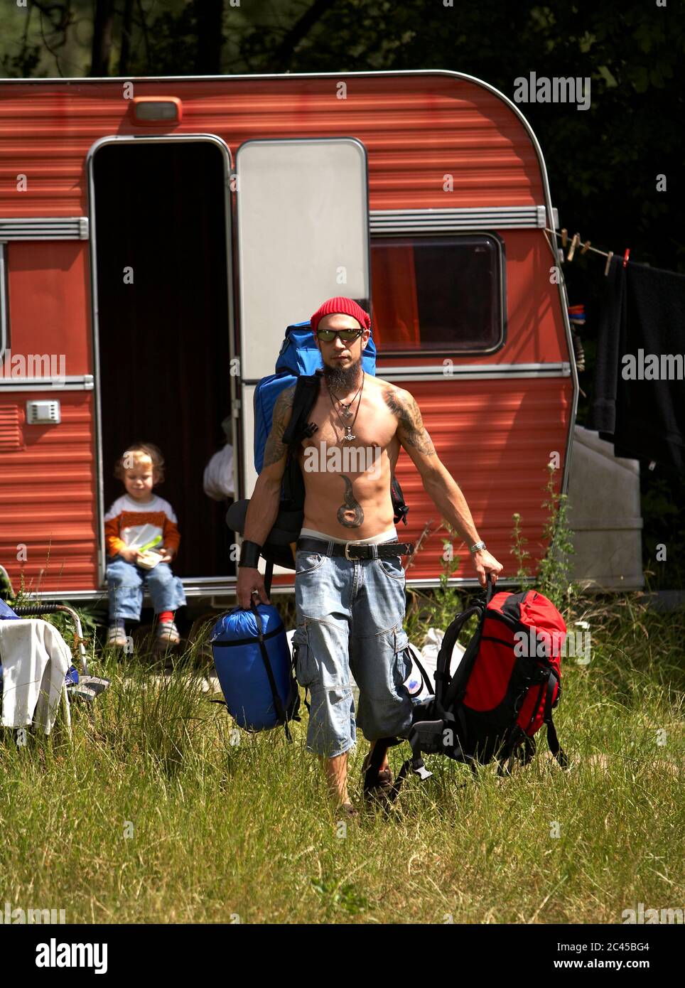 Man leaves a caravan with a boy Stock Photo - Alamy