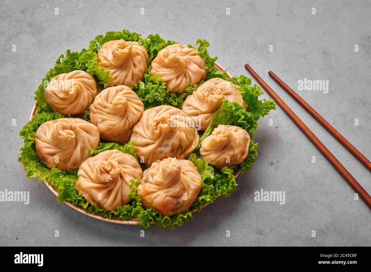 Veg Momos on gray concrete table top . Momos is the popular dish of ...
