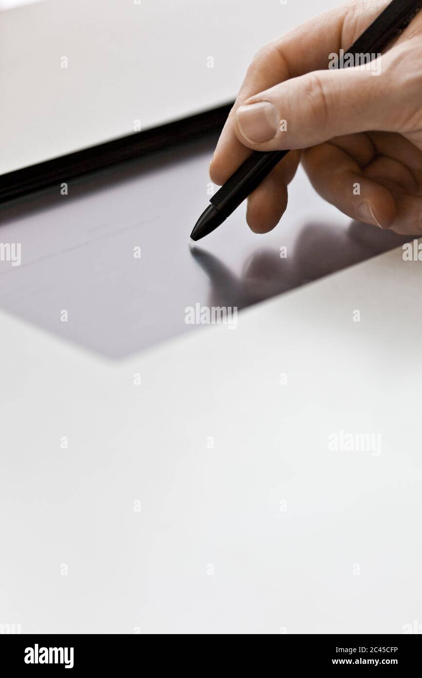 Person with pen writes on a display Stock Photo - Alamy