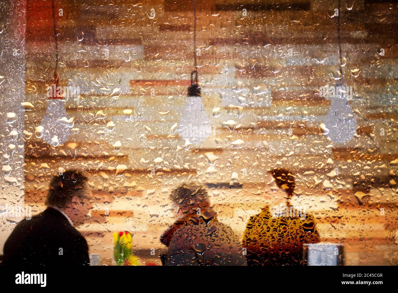 Three people behind a rainy window Stock Photo - Alamy