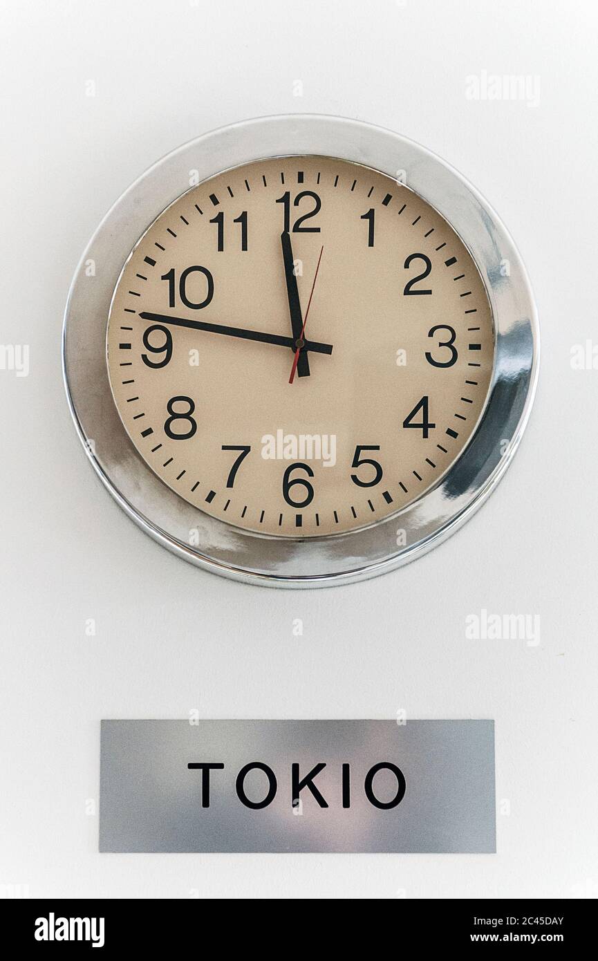 Wall clock over Tokyo sign Stock Photo - Alamy