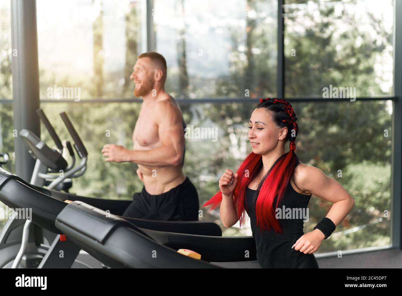 Gym treadmill running trainer man woman training together jogging ...