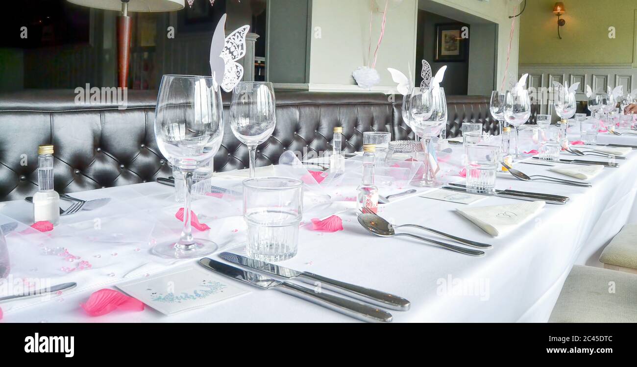 Wedding table setup detail with wine glasses and petals Stock Photo - Alamy