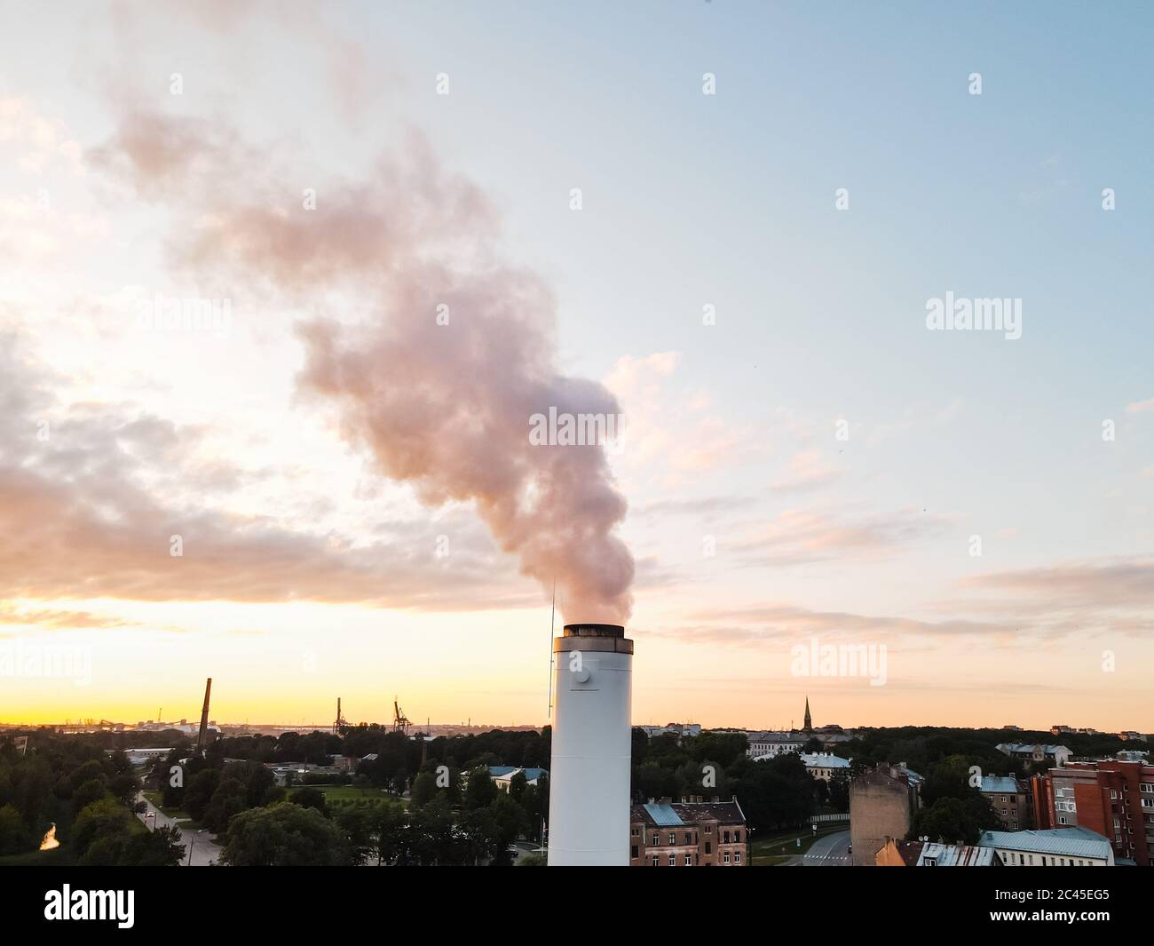 Large white pipe emits a lot of smoke causing greenhouse effect and ...