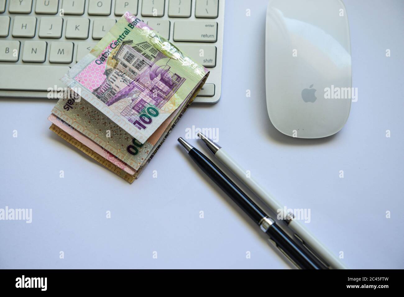 White Keyboard with Qatar Currency on white background Stock Photo - Alamy