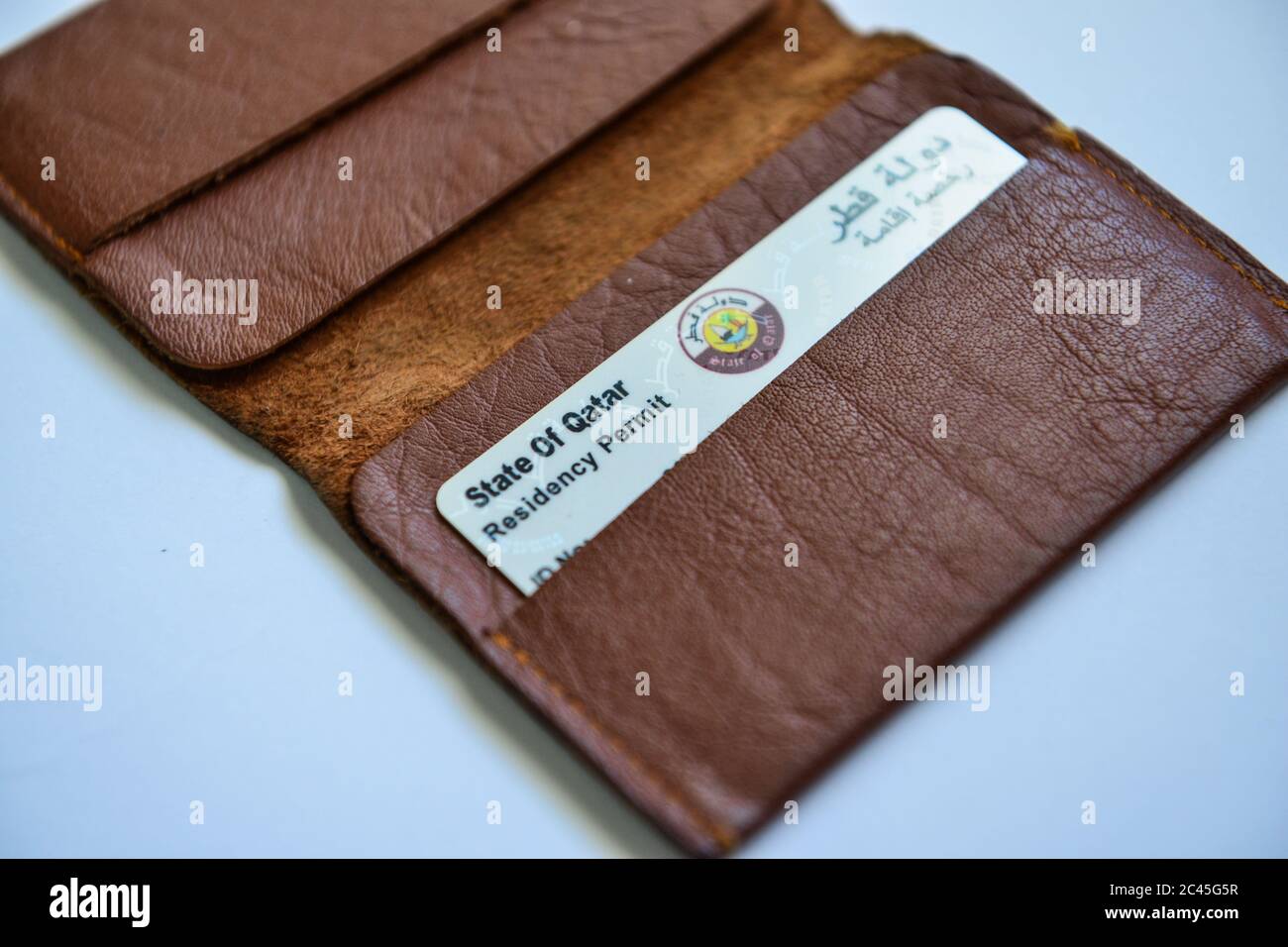Qatar ID card & Medical Card in Brown Valet on white background Stock ...