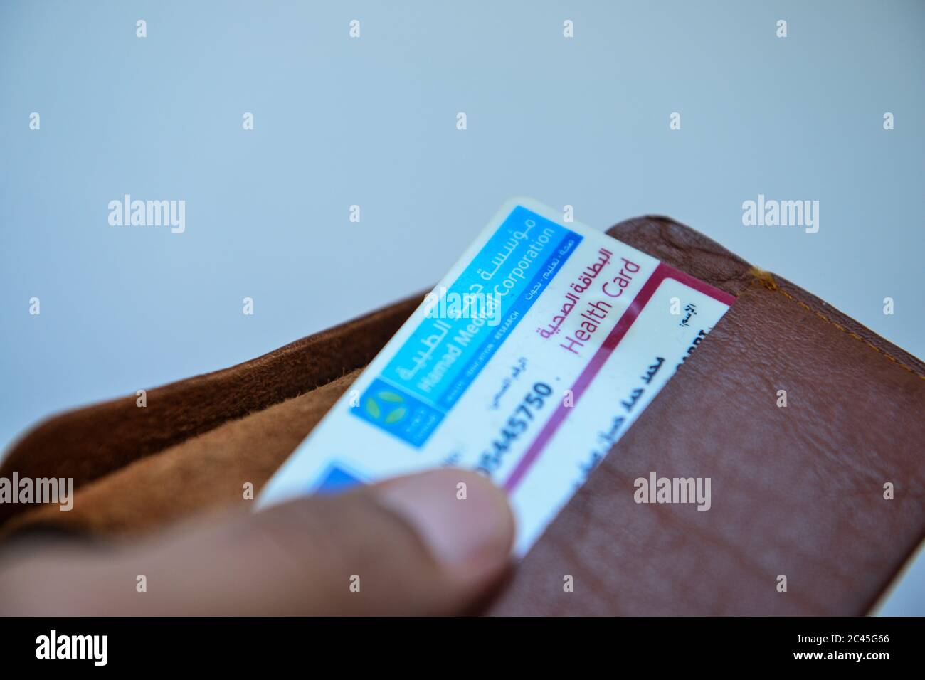 Qatar ID card & Medical Card in Brown Valet on white background Stock ...