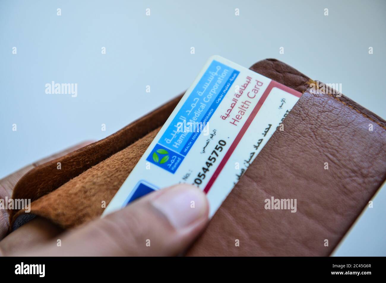 Qatar ID card & Medical Card in Brown Valet on white background Stock ...