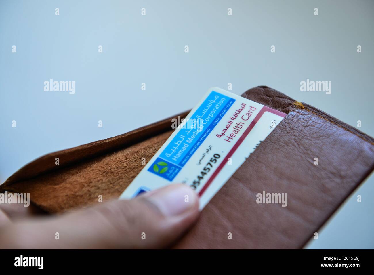 Qatar ID card & Medical Card in Brown Valet on white background Stock ...
