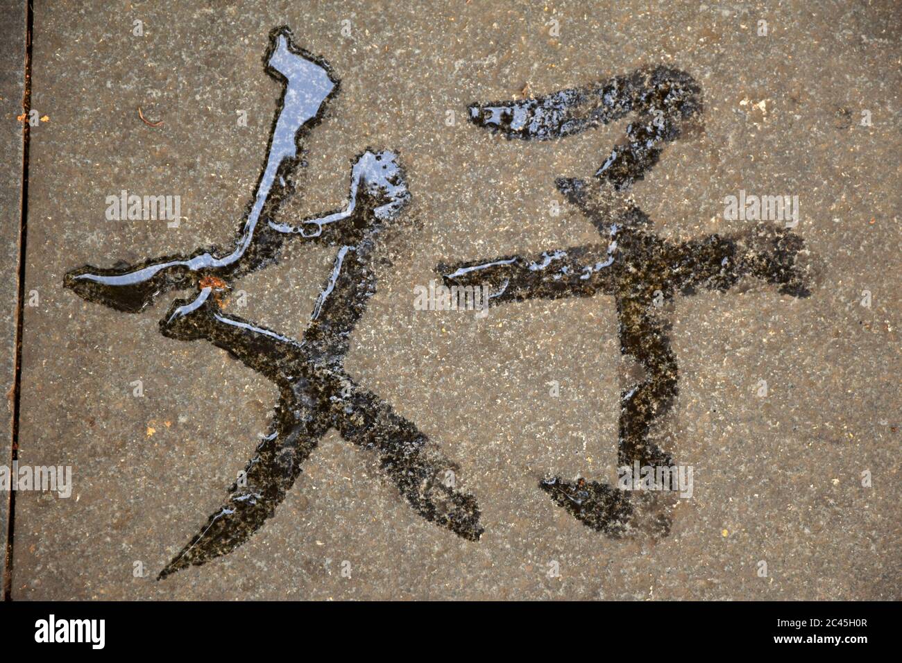 A Chinese calligraphy written with water on the cement ground in a park ...