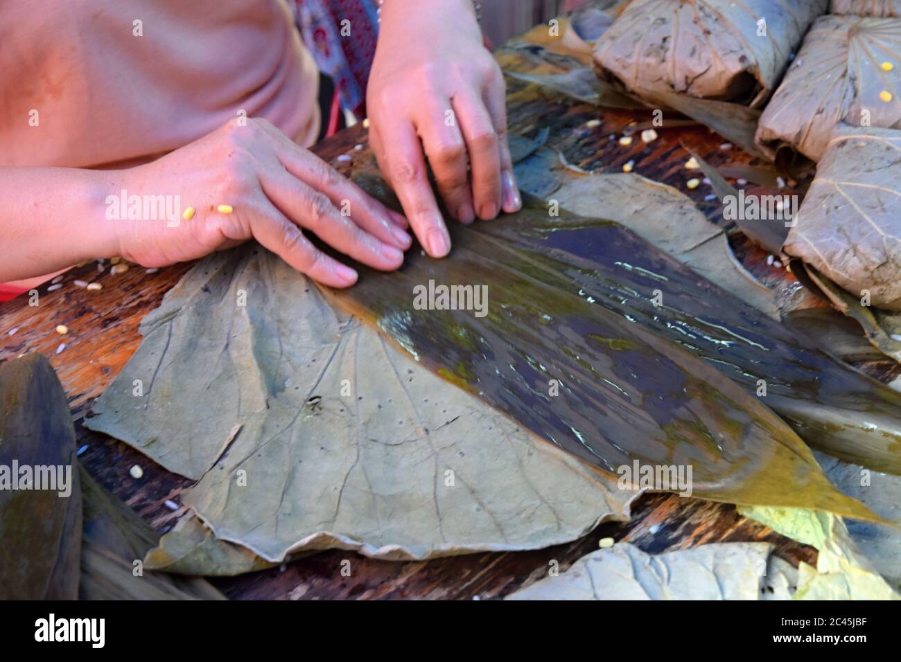 Making zongzi, a traditional Chinese rice dish which is made of ...