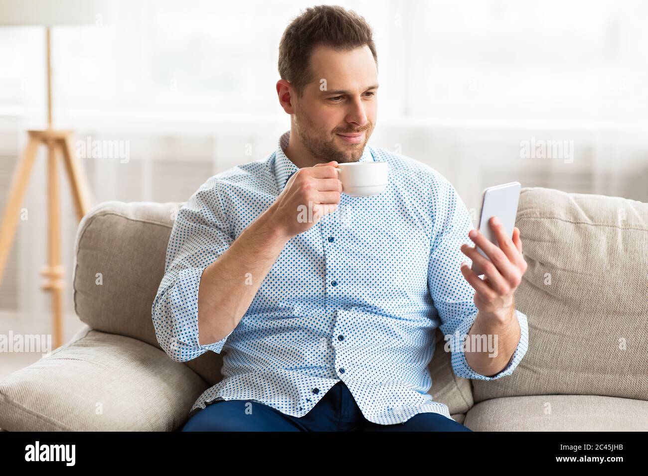 Happy man using smart phone for video call Stock Photo - Alamy