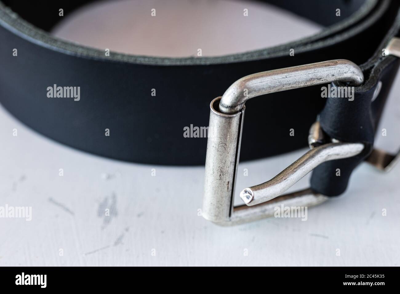 Leather belt for trousers on a white table. Haberdashery. Belt with a ...