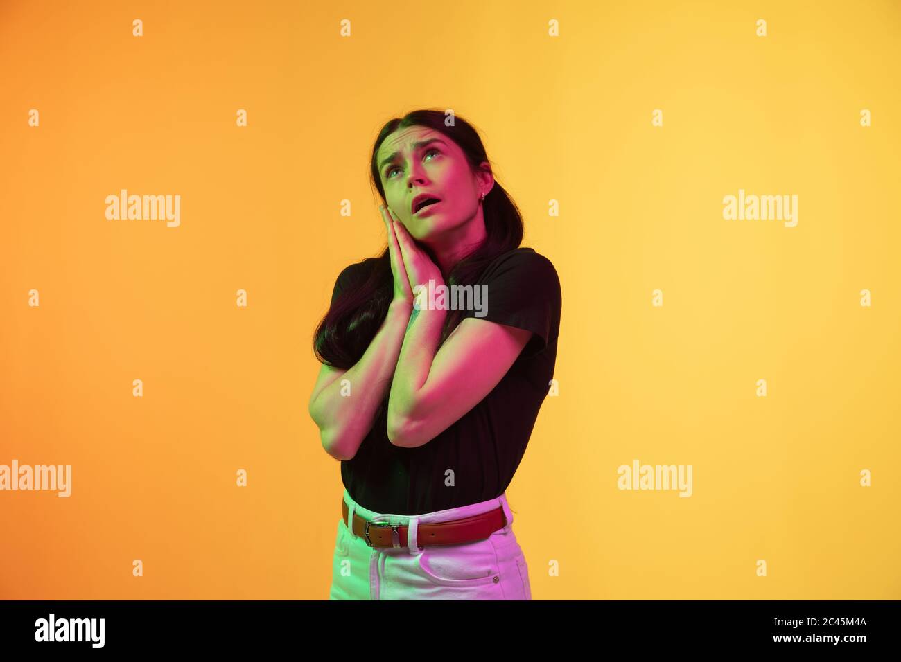 Upset, dissapointed. Caucasian young woman's portrait on yellow studio ...