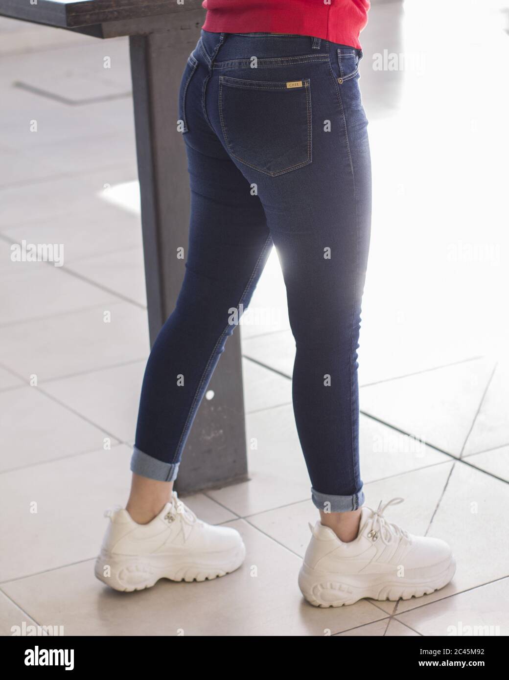 Shot of a female wearing a classic and beautiful dark blue jeans Stock ...