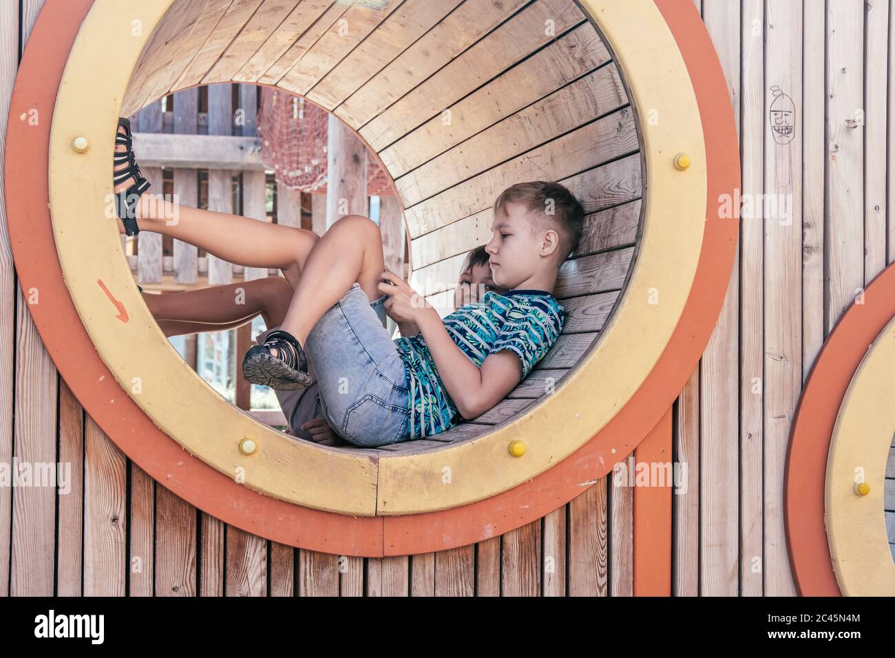 Handsome boy with smartphone playing game Stock Photo - Alamy