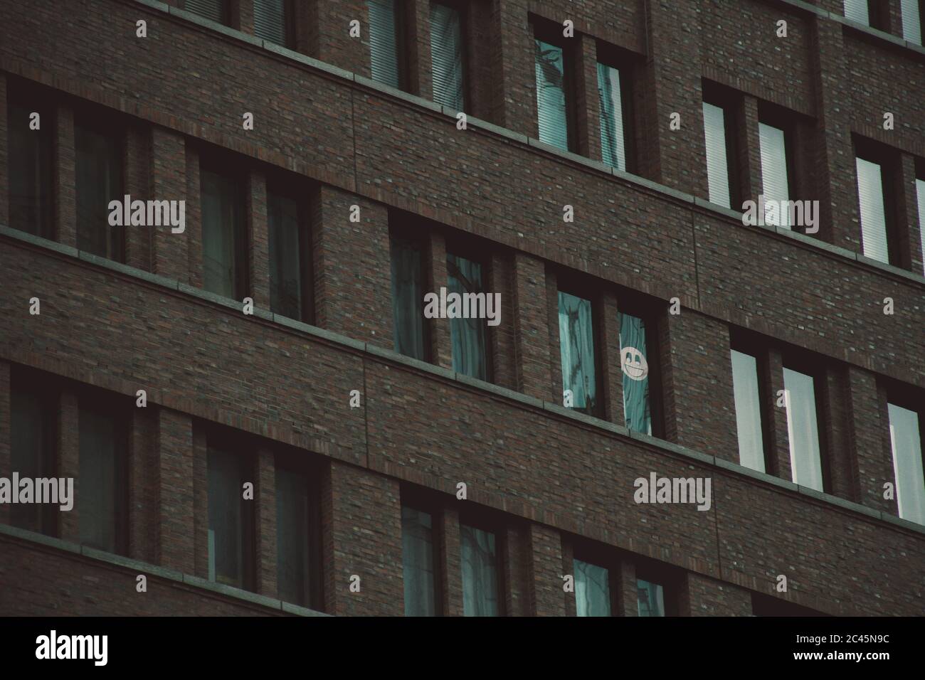 Low angle shot of the glass windows and concrete exterior wall of a ...