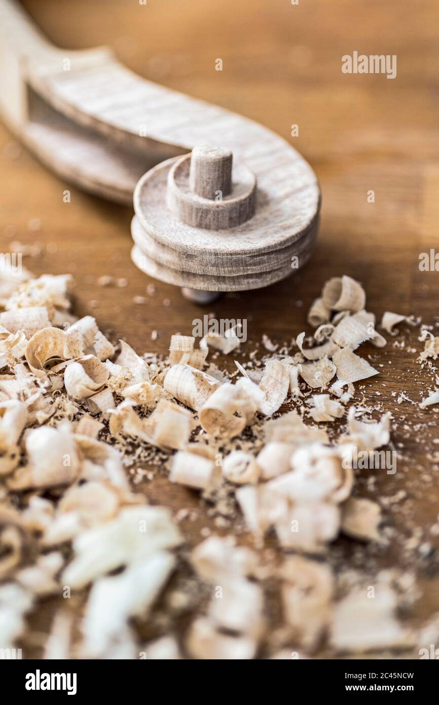 Unfinished violin snail and wood shavings, close-up Stock Photo - Alamy