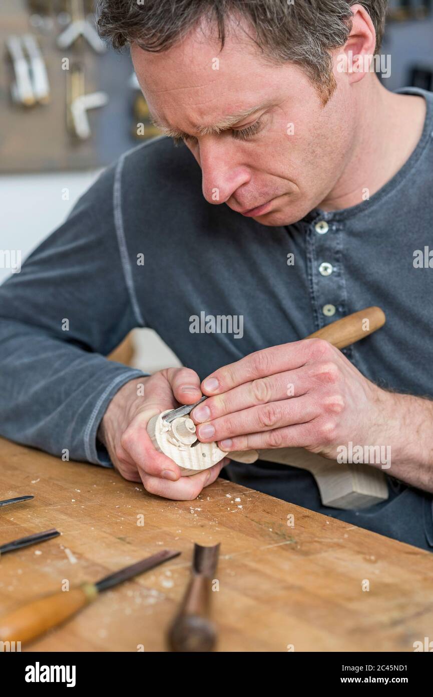 Violin maker works on a violin snail Stock Photo - Alamy