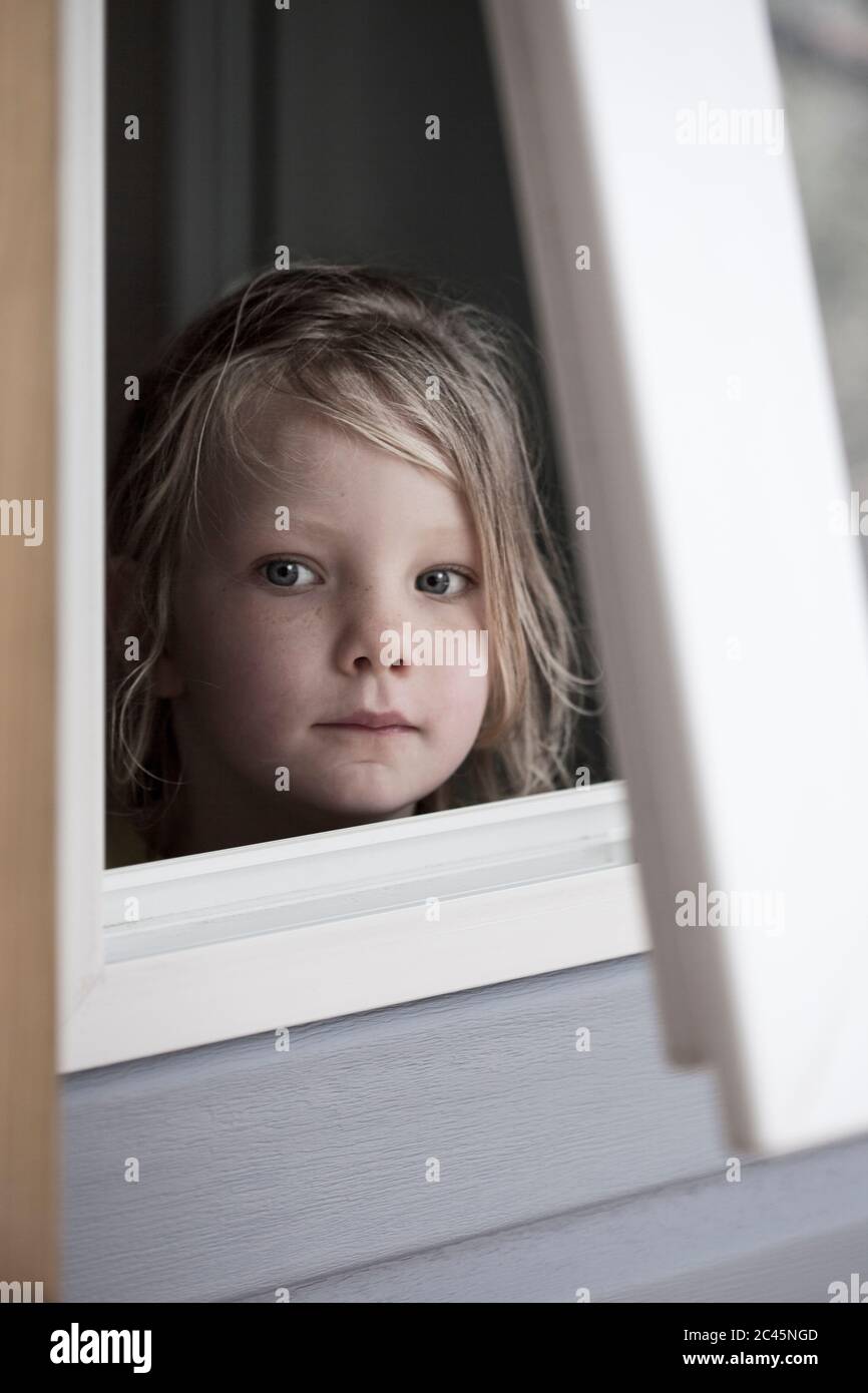 Girl looks out the window Stock Photo - Alamy