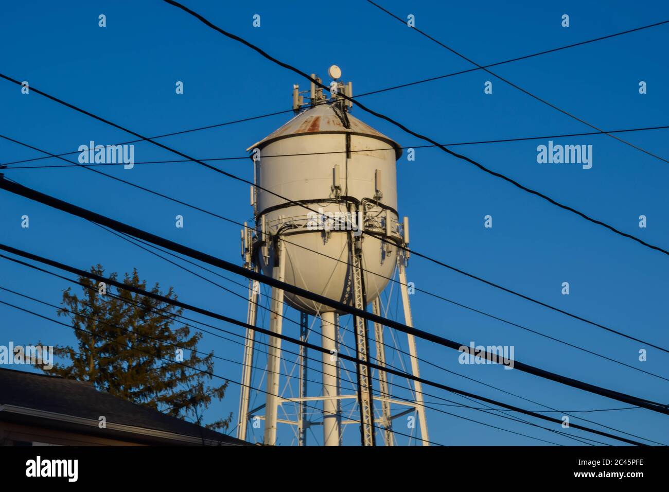 Old rusty water tower against the blue sky Stock Photo - Alamy