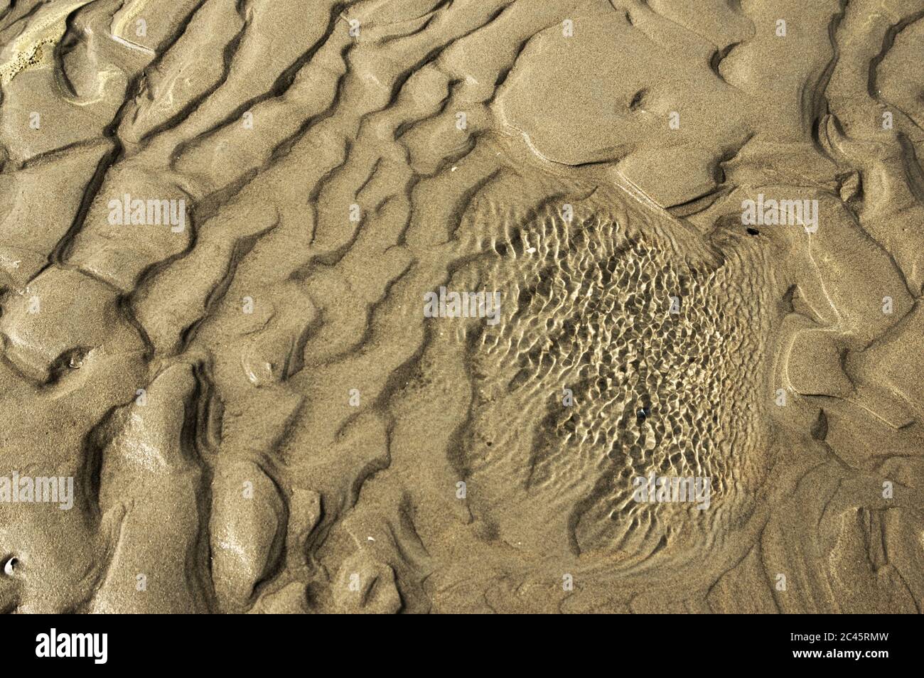 Beach with water puddle and sand Stock Photo - Alamy