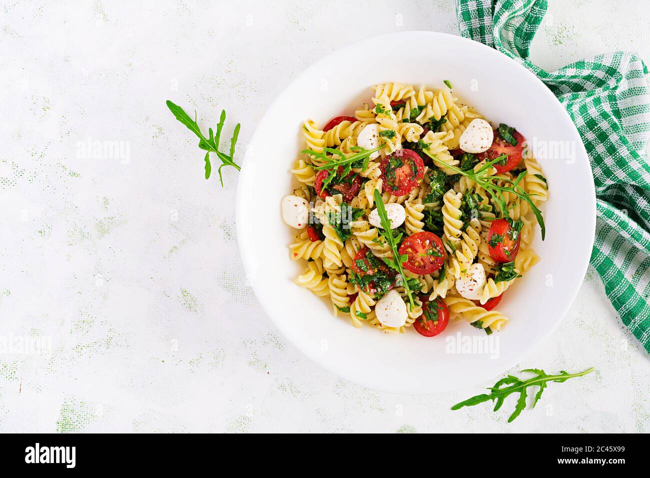 Pasta salad. Fusilli Pasta - Caprese salad with tomato, mozzarella and ...