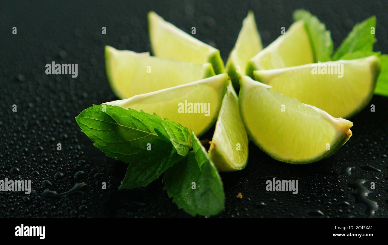 Lime segments with mint leaves Stock Photo - Alamy