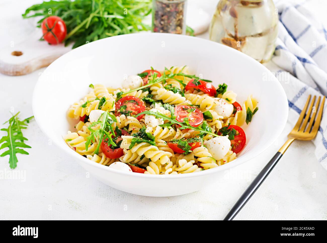 Pasta salad. Fusilli Pasta - Caprese salad with tomato, mozzarella and ...