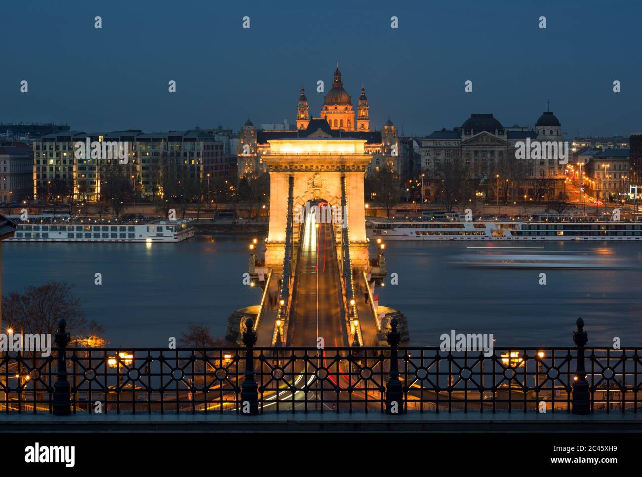 Chain Bridge by night against Budapest waterfront Stock Photo - Alamy