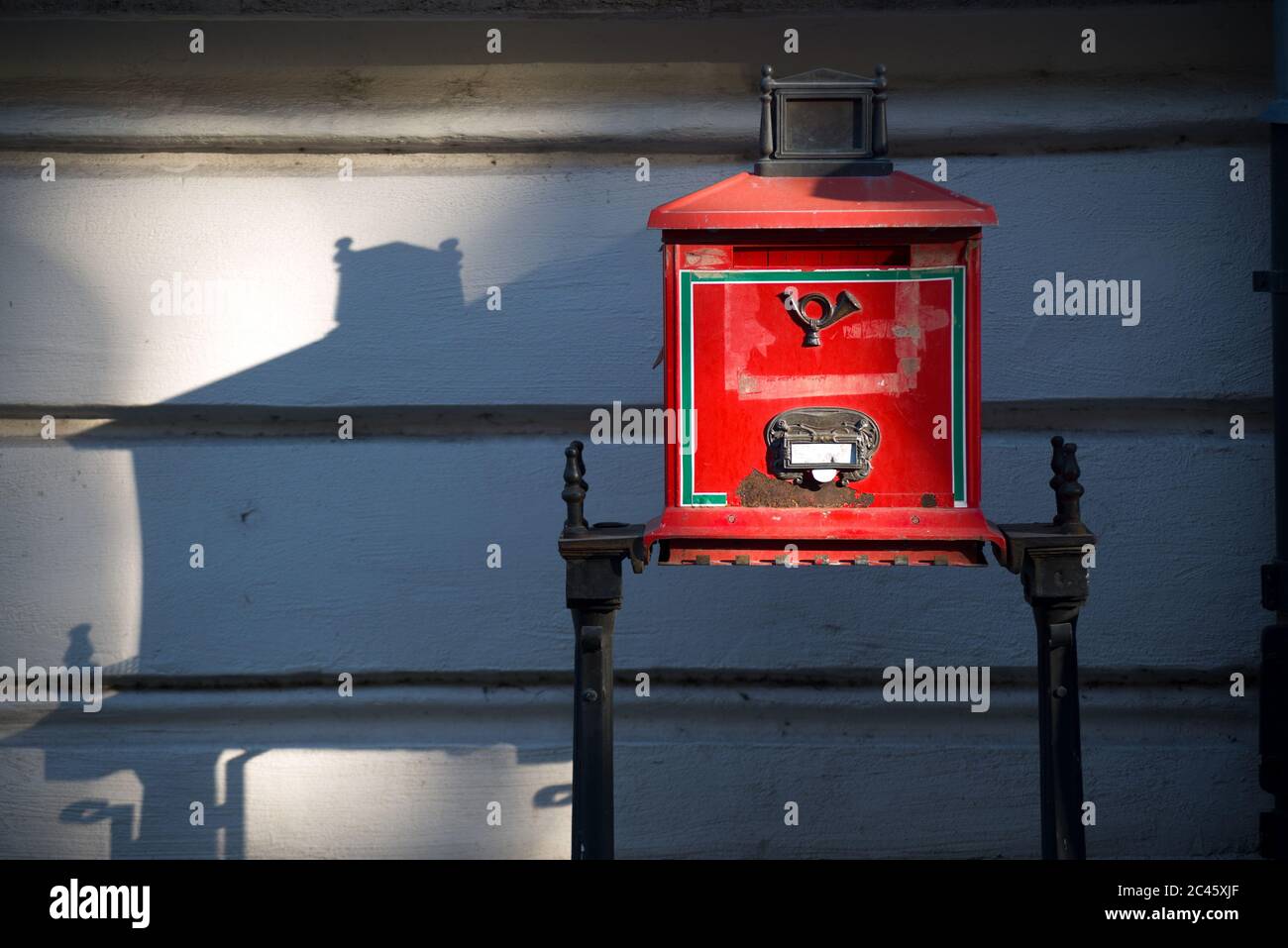 Red old-time post box and it's shadow on the wall Stock Photo - Alamy
