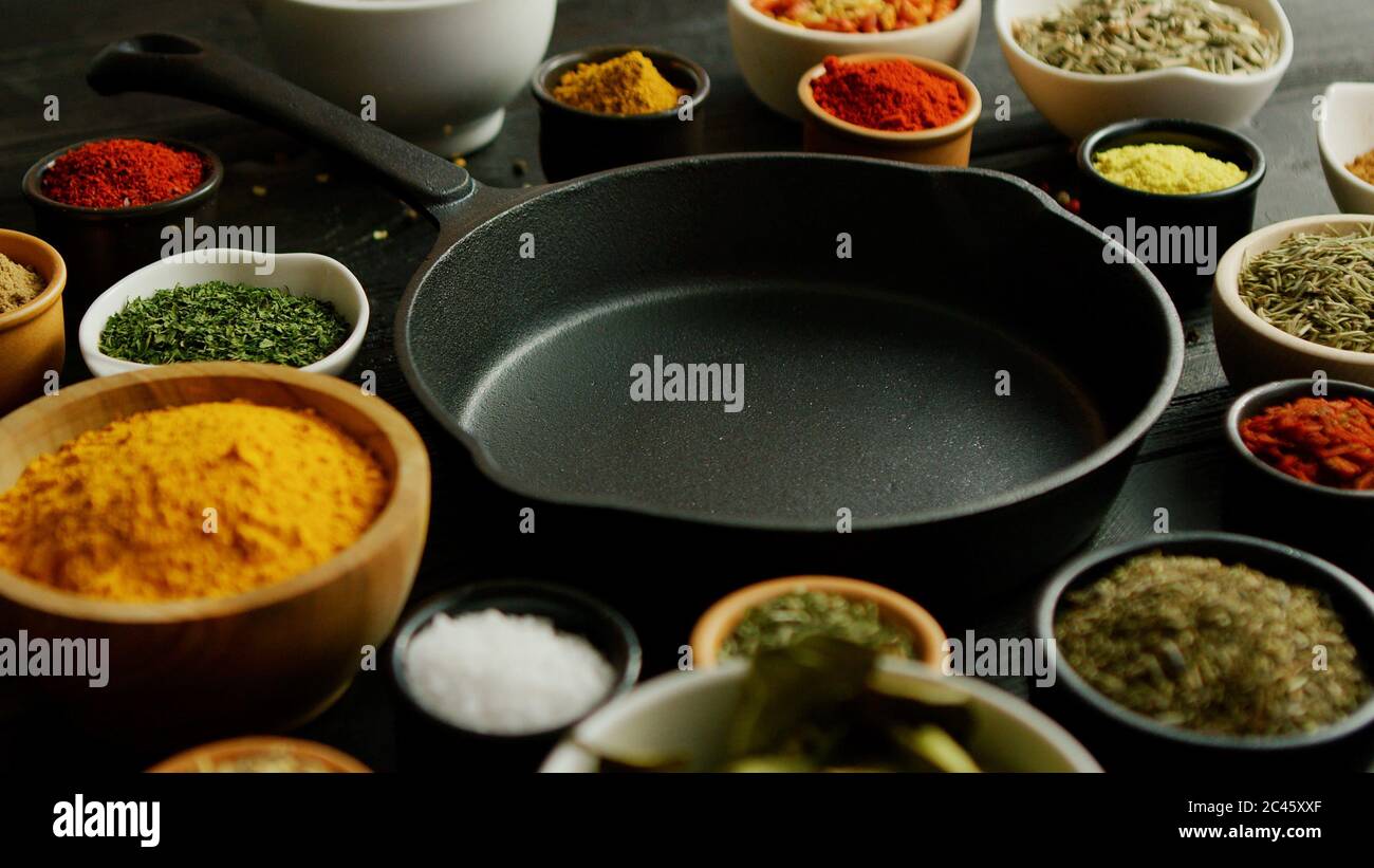Bowls with spices and pan Stock Photo - Alamy