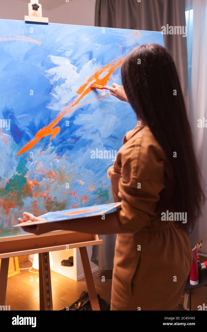 Successful artist in art studio painting a colorful masterpiece Stock ...