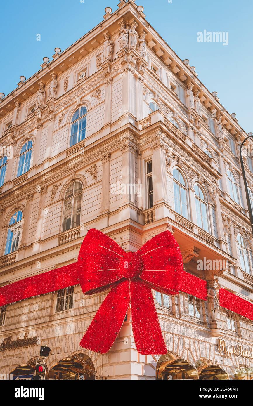 Giant decorative red Christmas bow on building Stock Photo - Alamy