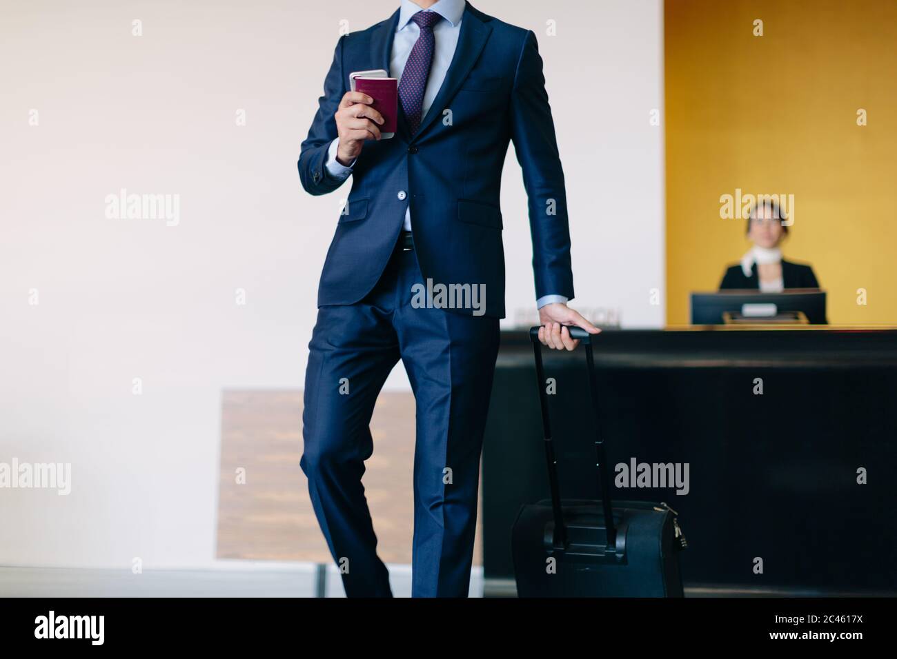 Businessman checking out of hotel Stock Photo - Alamy
